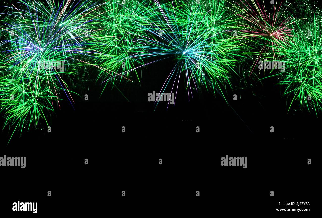 Vibrant green fireworks in the dark night sky Stock Photo - Alamy