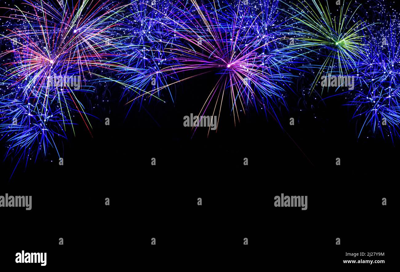 Vibrant blue fireworks in the dark night sky Stock Photo - Alamy