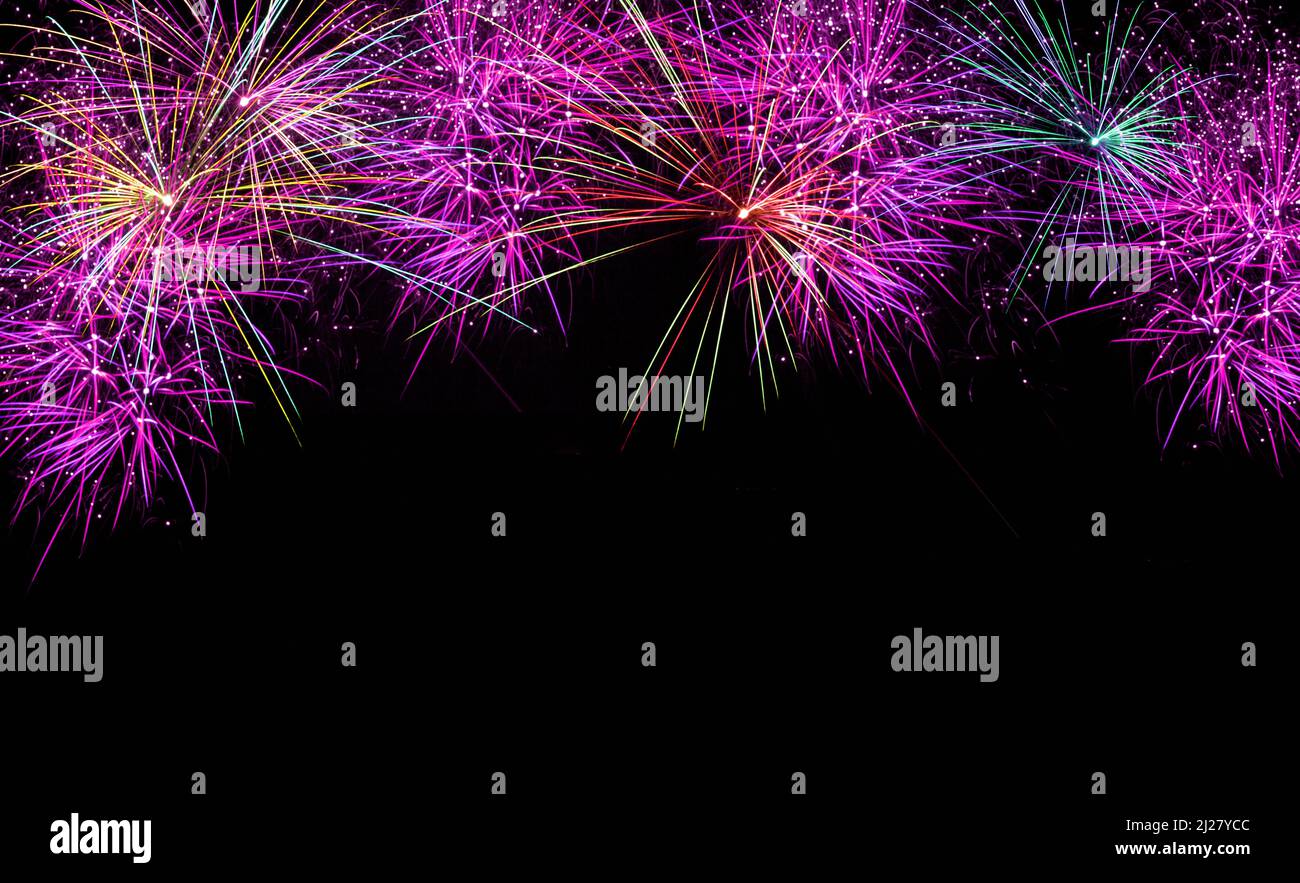 Vibrant pink fireworks in the dark night sky Stock Photo - Alamy