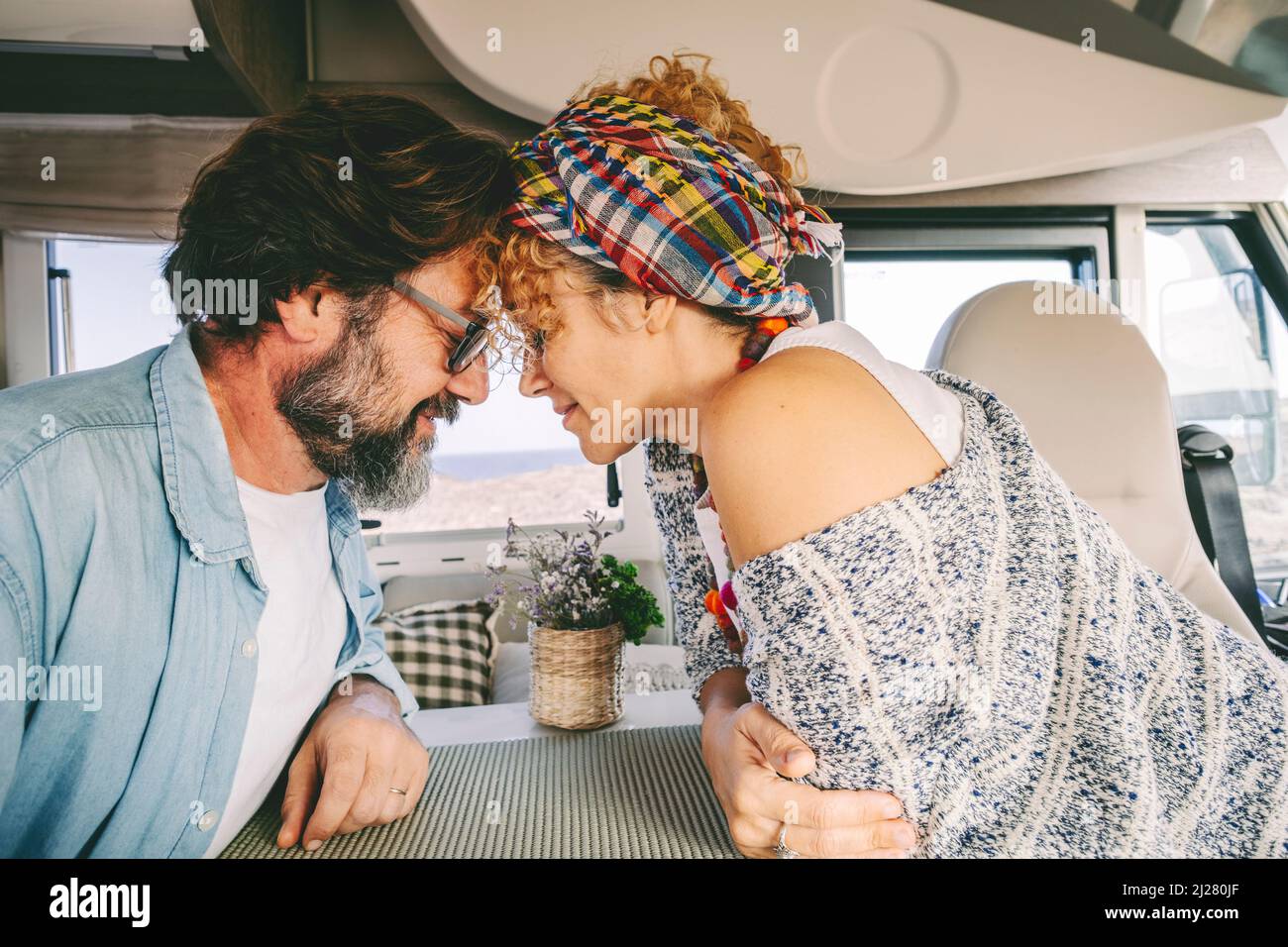 Adult couple in love and relationship activity together inside camper ...