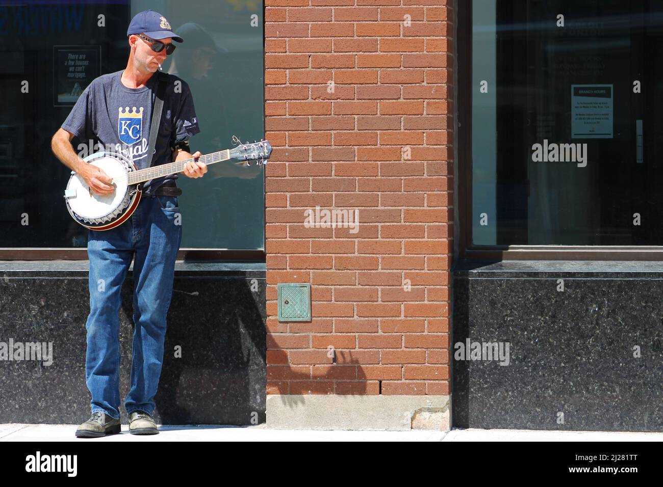 A busker playing a banjo on Water Street, St. John's, NL Stock Photo ...