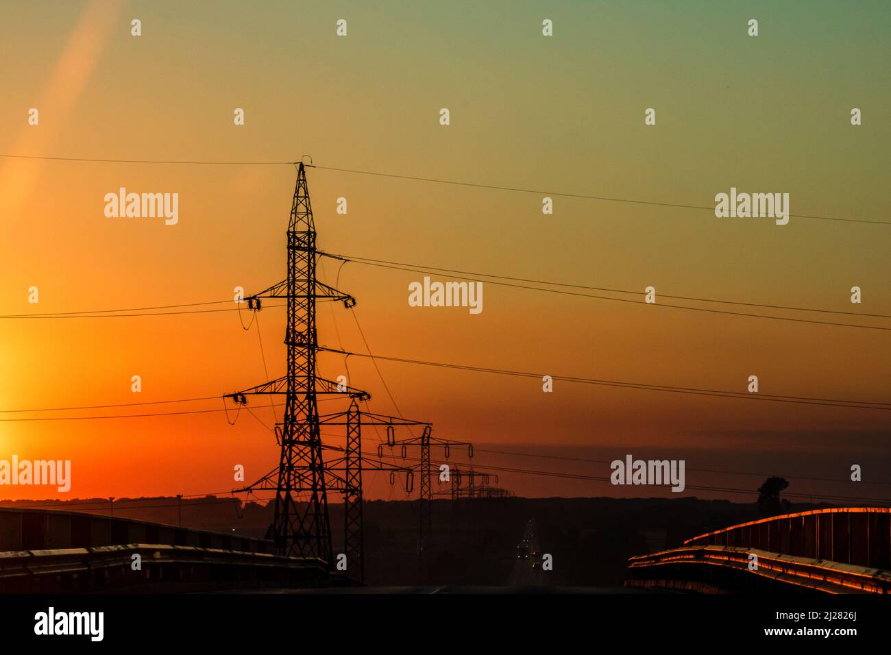 Electric power pylon, electric tower at sunset Stock Photo - Alamy