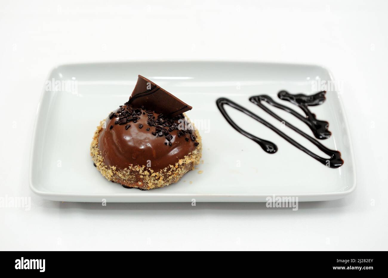 A top view of a chocolate cake with chocolate design on a white ...