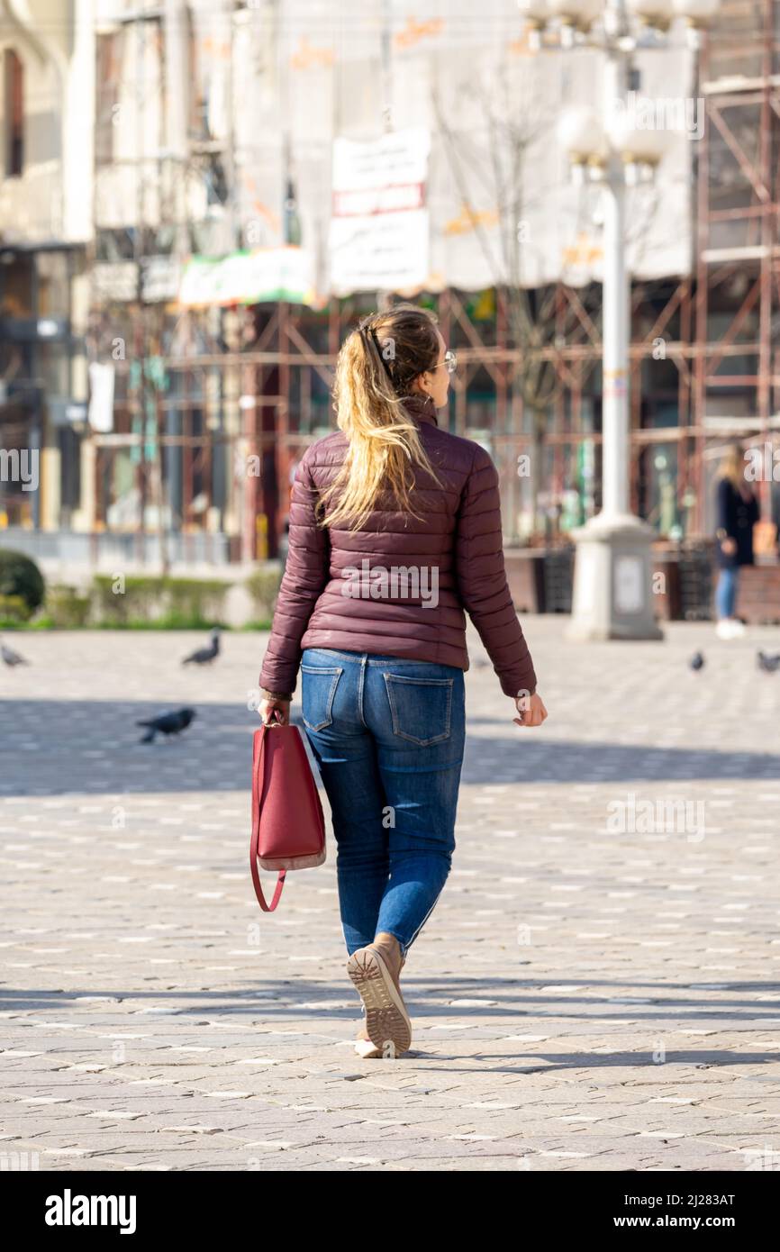 Woman walking on the street. Real people Stock Photo - Alamy