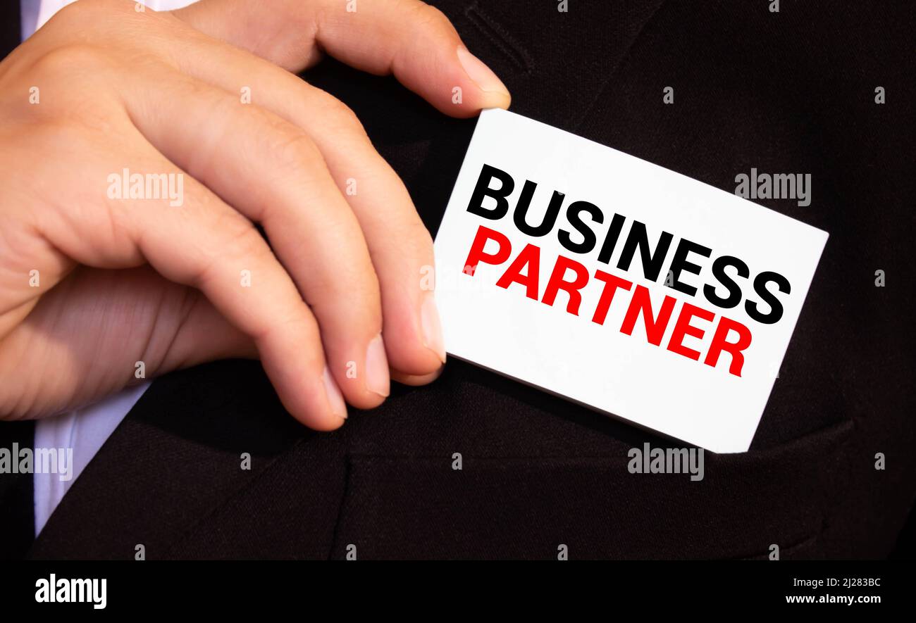 BUSINESS PARTNER text on paper sheet with chart, dice, spectacles, pen ...