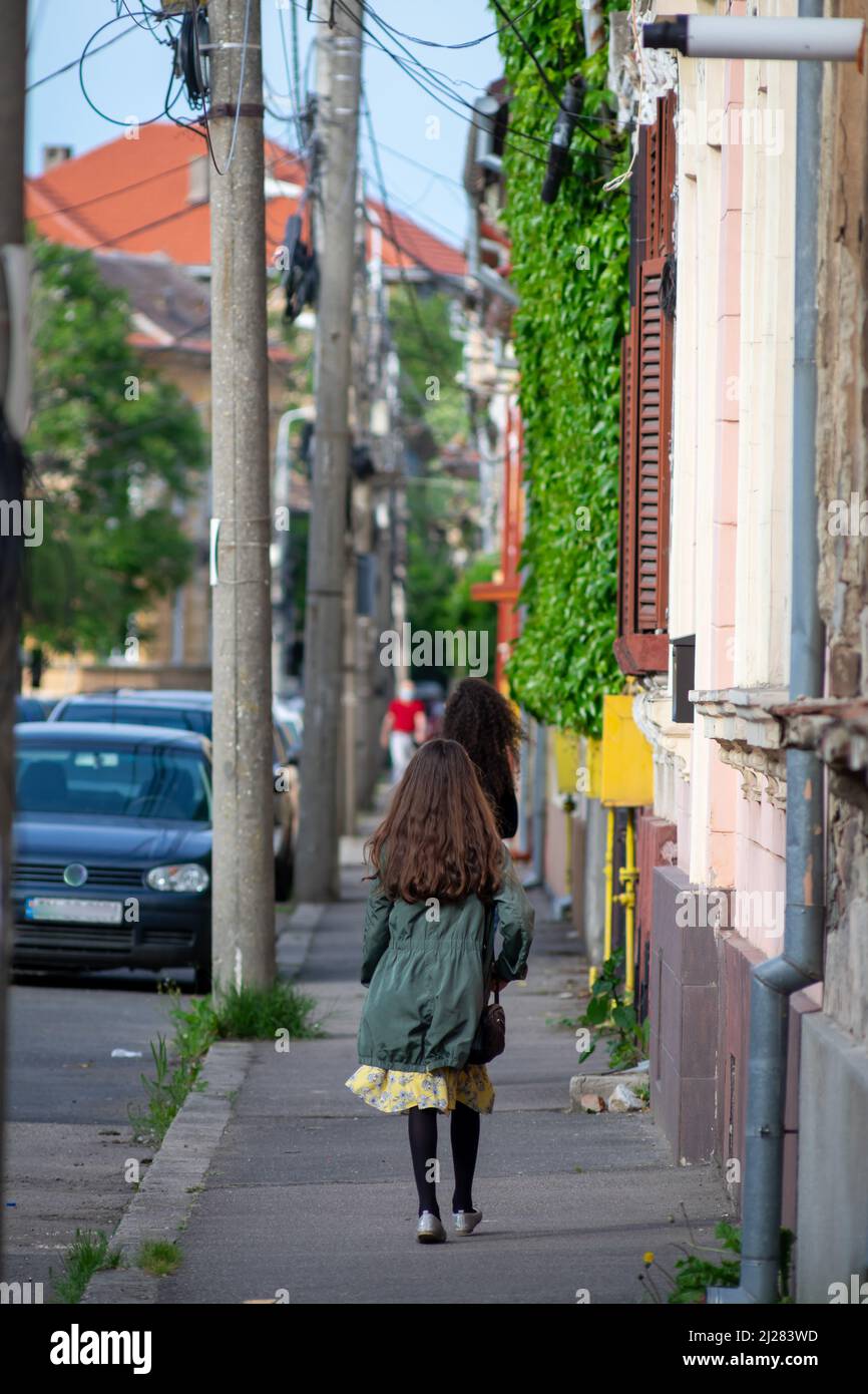 Woman walking on the street. View from behind. Real people Stock Photo ...