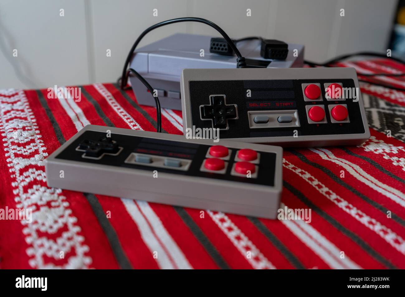Retro gaming console with classic gamepad controller on a table Stock ...