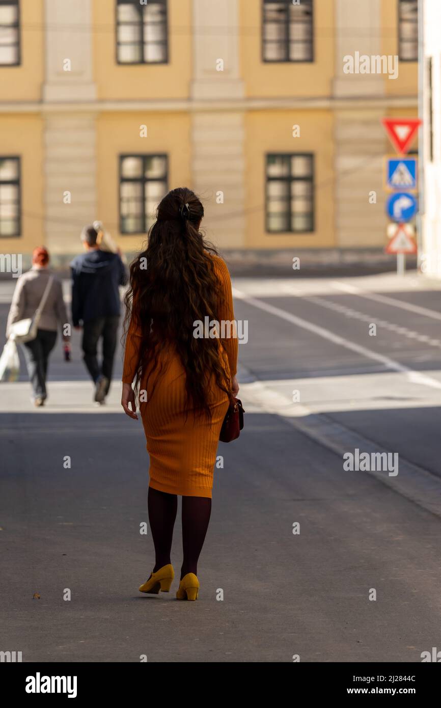 Woman walking on the street. Real people Stock Photo - Alamy