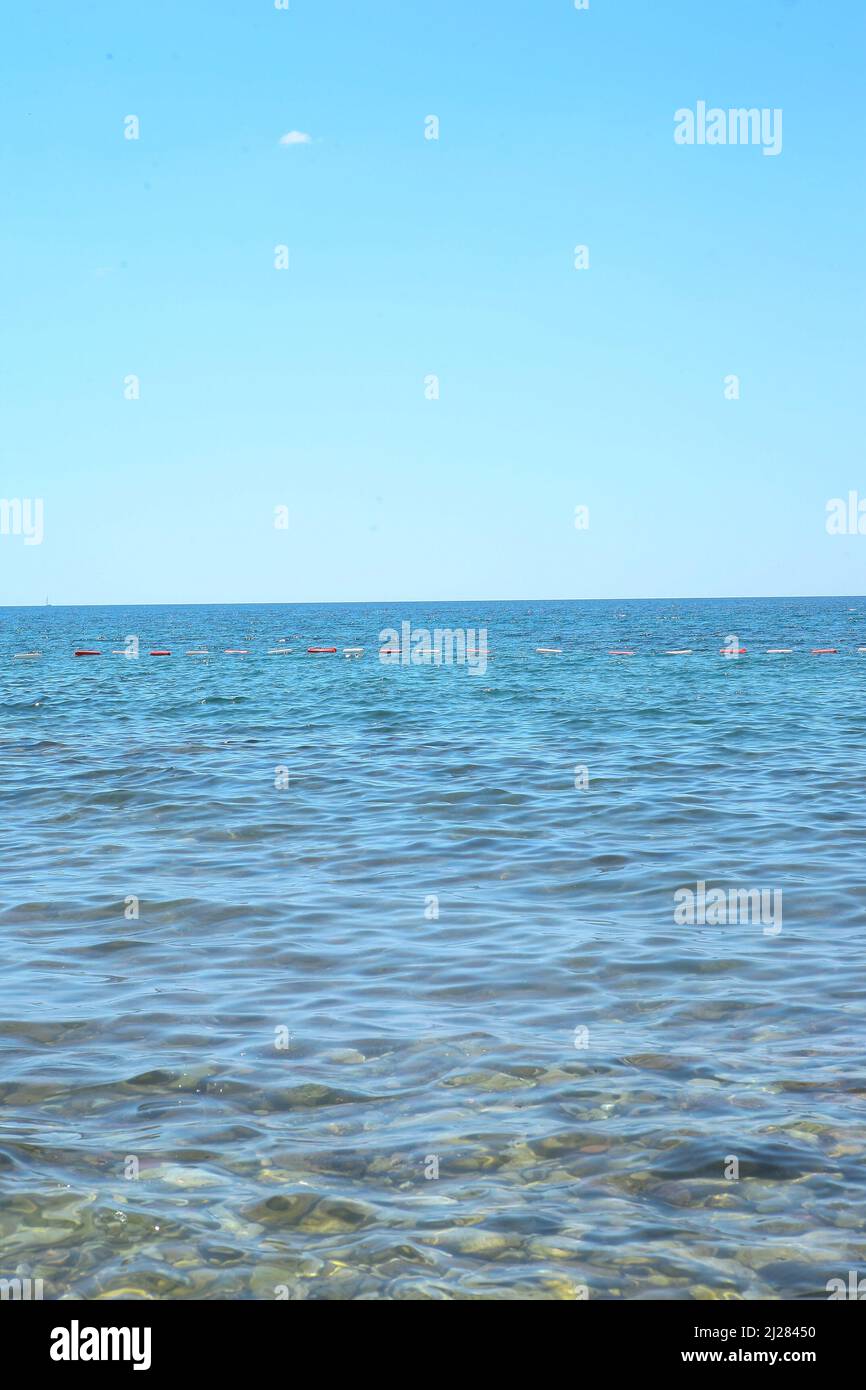Blue seascape with light blue sky on sunny day. A backing with sea and ...