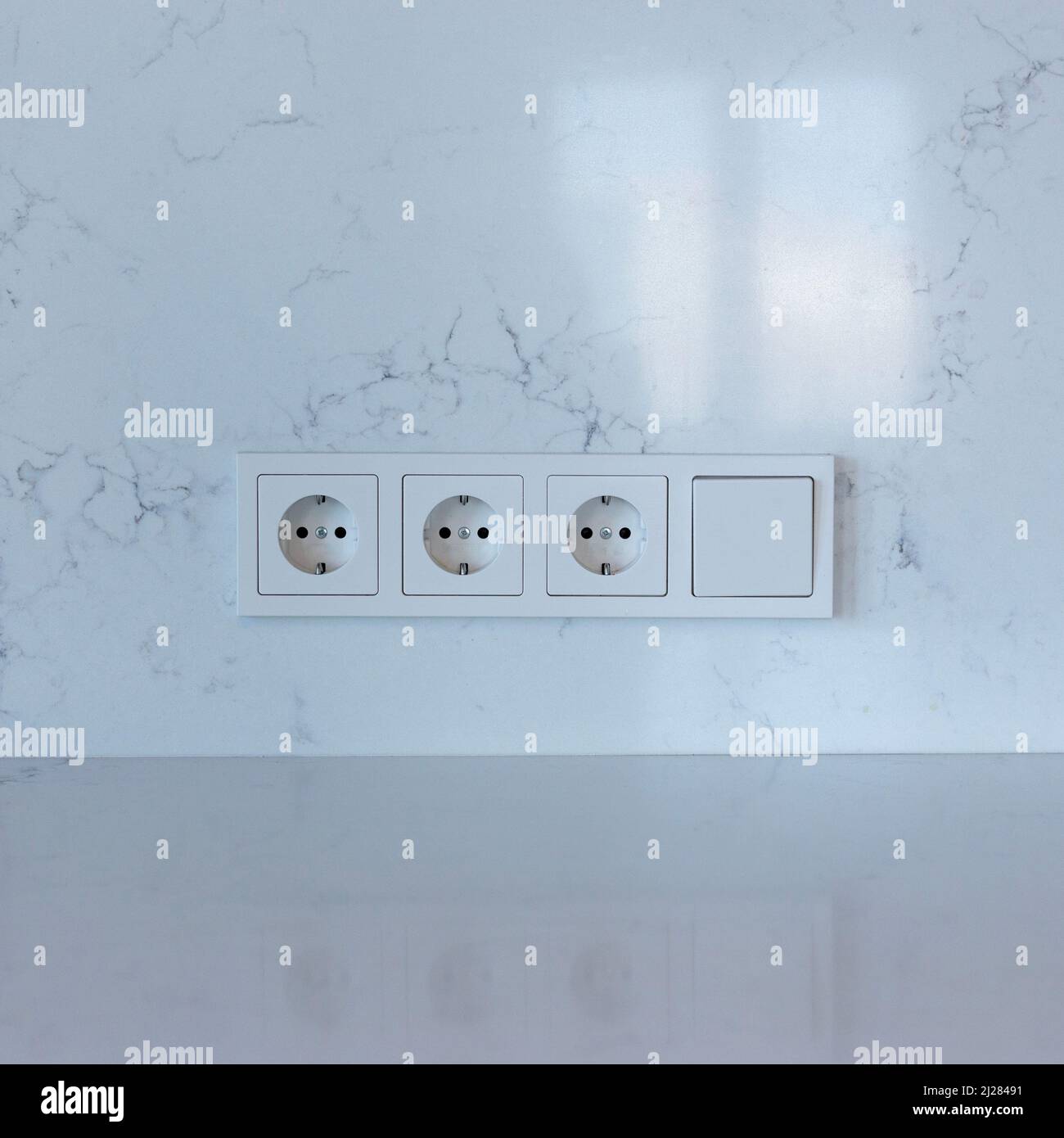 Block of three sockets and a switch on a white wall Stock Photo - Alamy