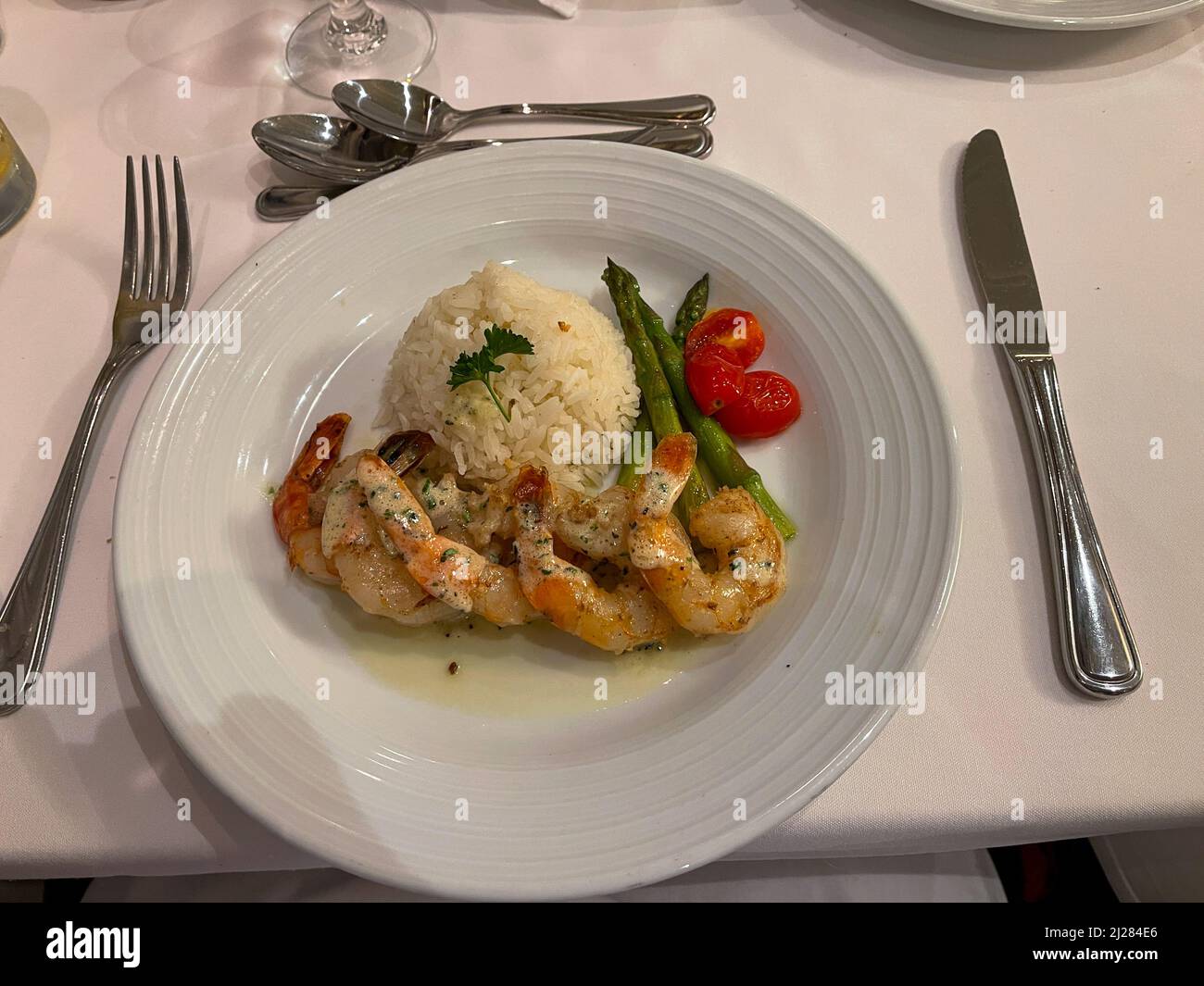 A dinner of shrimp, rice and asparagus at a cruise ship restaurant ...