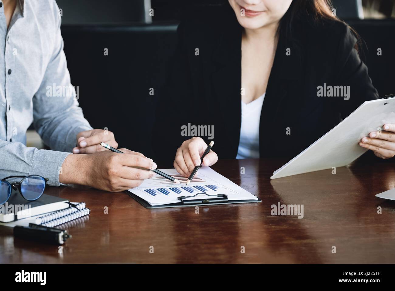 Teamwork concept, consultation, male economist holding pen pointing to ...