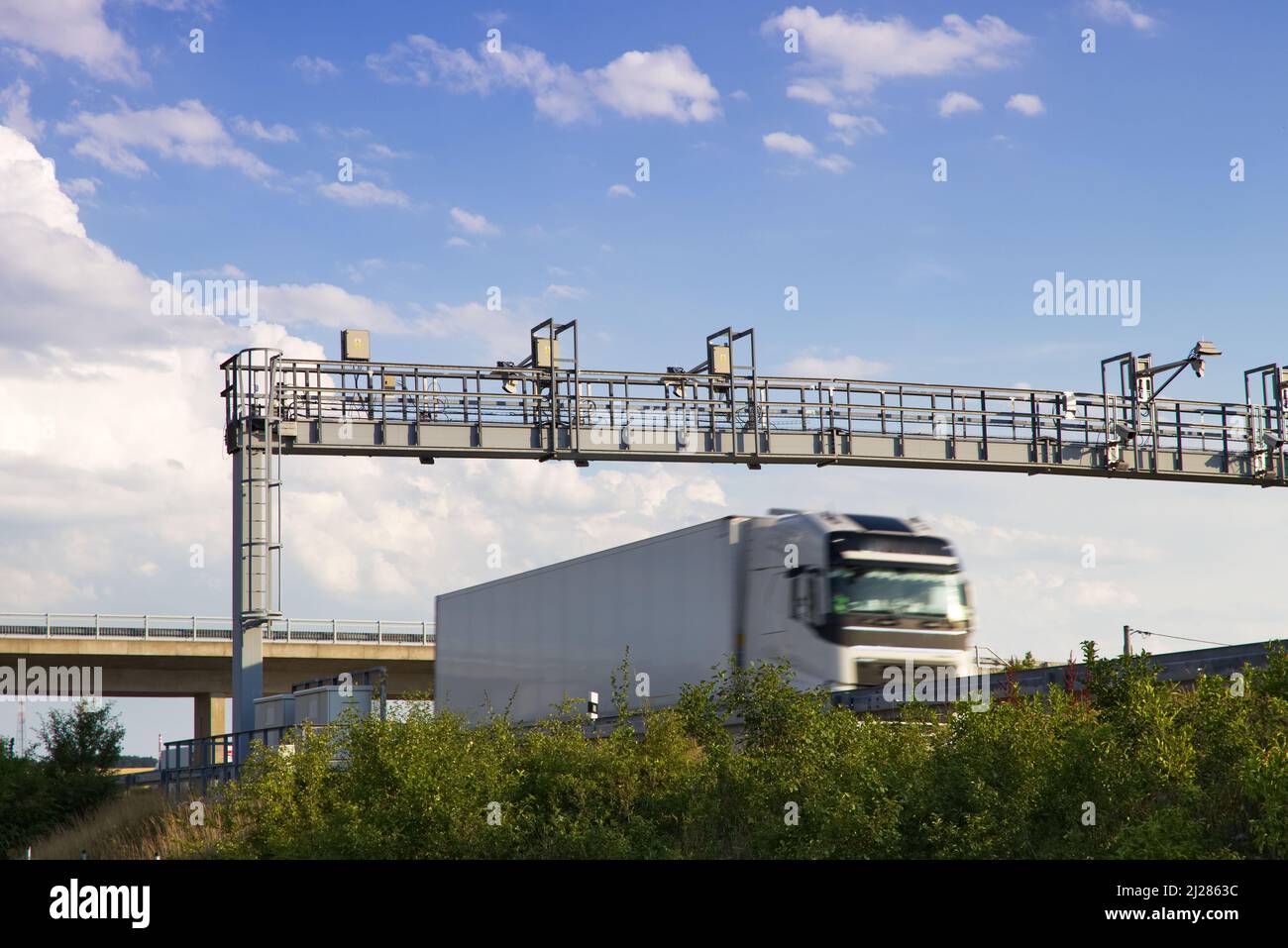 Truck drive under the highway toll gate, lorry in motion ...