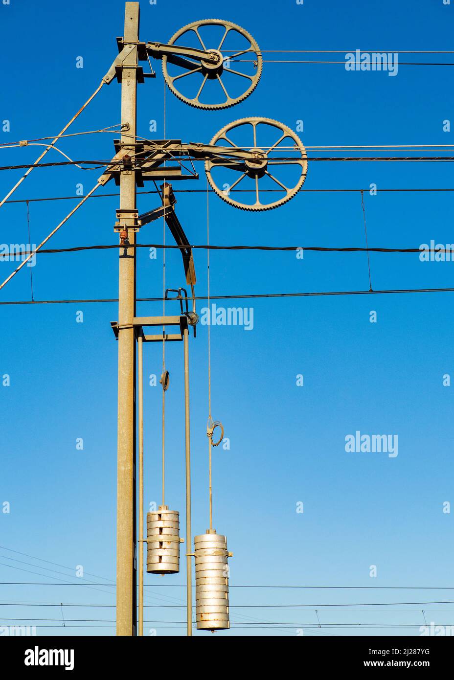 Post with counterweights at a railway station Stock Photo - Alamy