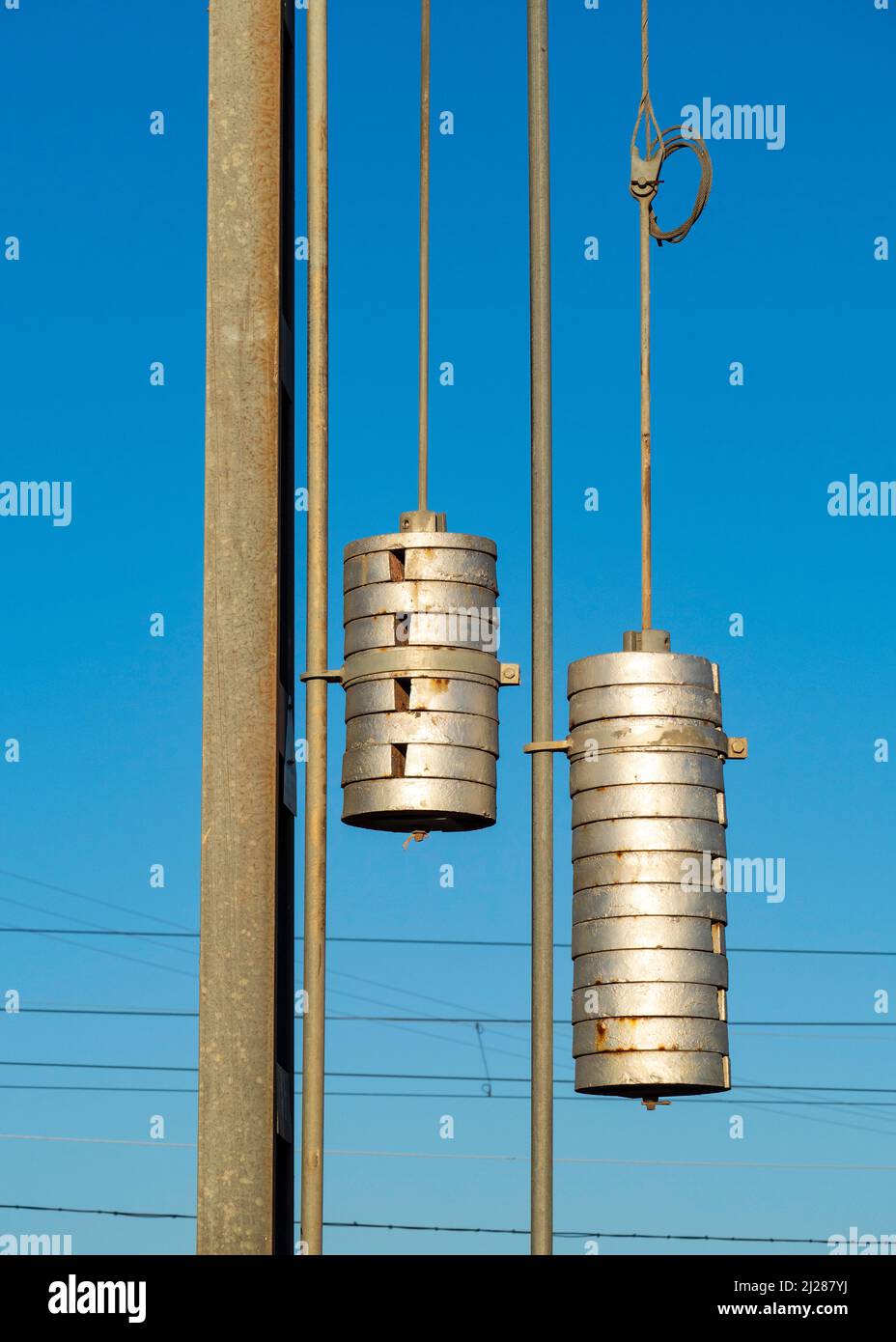 Post with counterweights at a railway station Stock Photo - Alamy