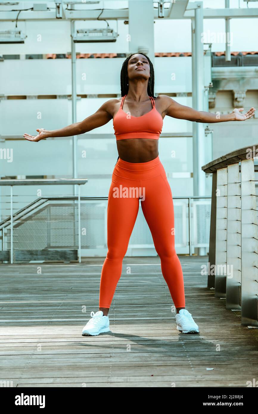 Beautiful young woman runner outdoor in sport outfit stretching ...