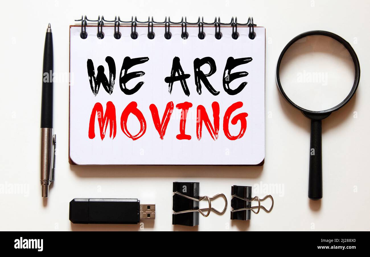 Notepad with text We Are Moving. White background. Business Stock Photo ...