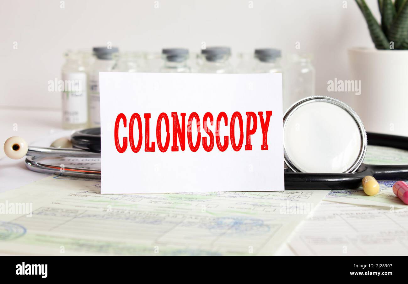 Colonoscopy word written on medical blue folder with patient files ...