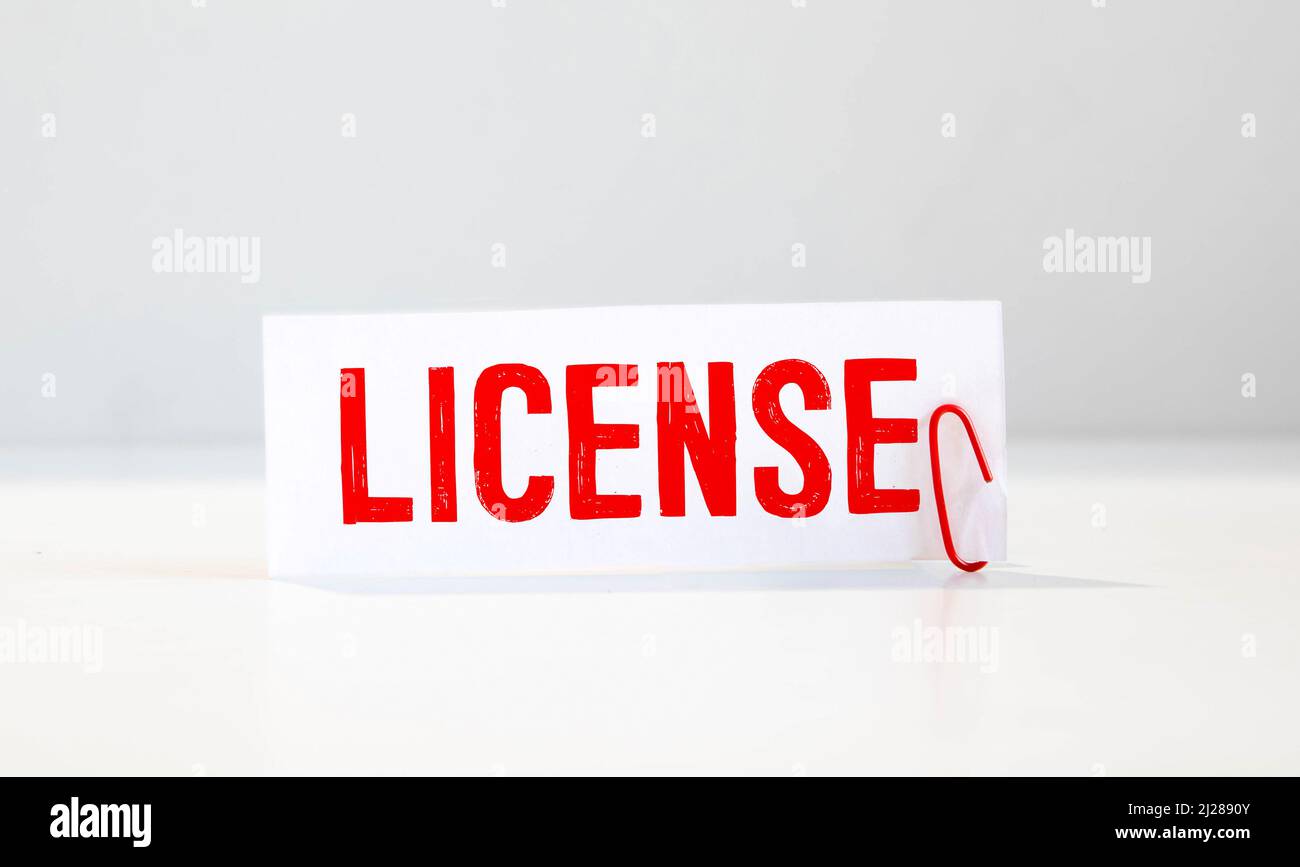 Text LICENSE on stickers,pen on the background of documents. Financial ...