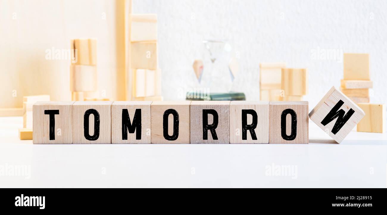 Tomorrow word written on wood block, concept Stock Photo - Alamy