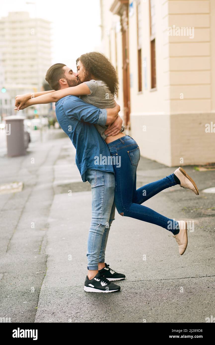 He knocks me off my feet. Shot of a loving couple out in the city Stock ...
