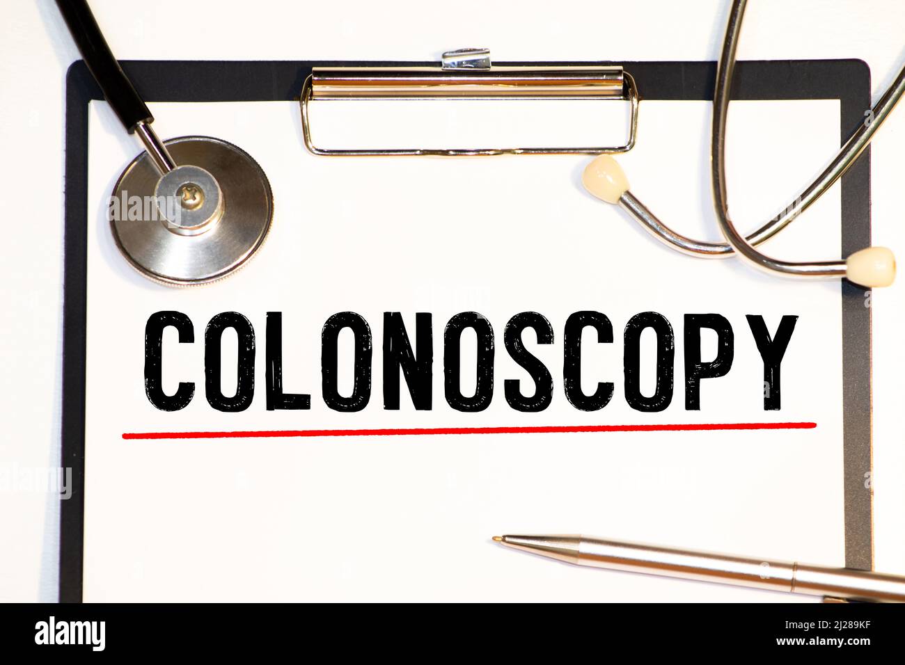Colonoscopy word written on medical blue folder with patient files ...