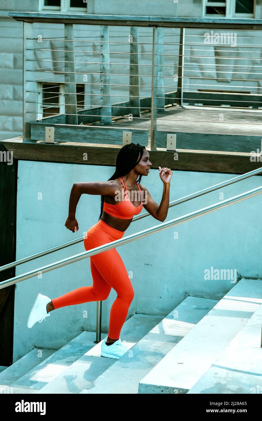 Beautiful young woman runner outdoor in sport outfit stretching ...