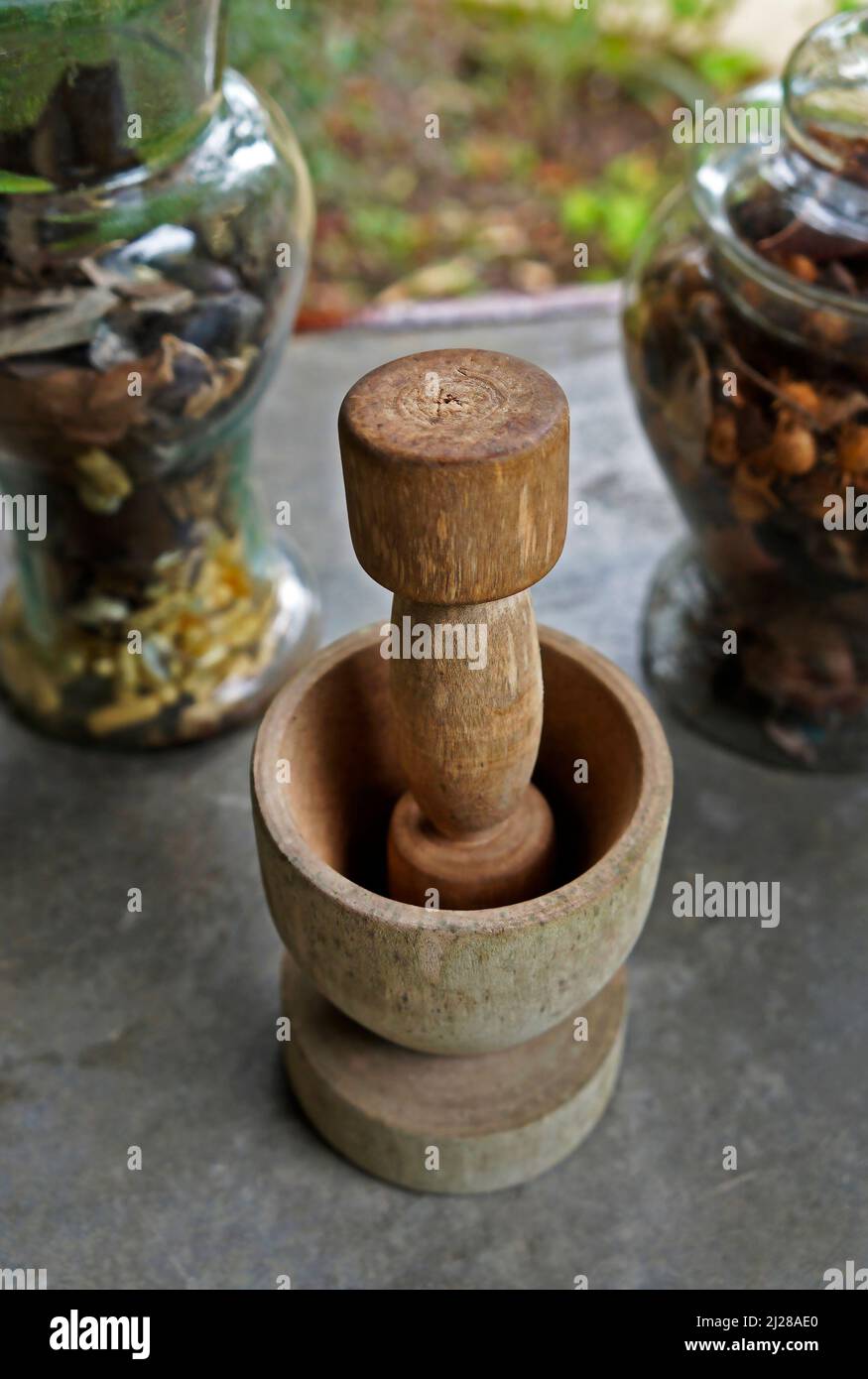 Wooden pestle and mortar with with herbal jars on the background Stock ...