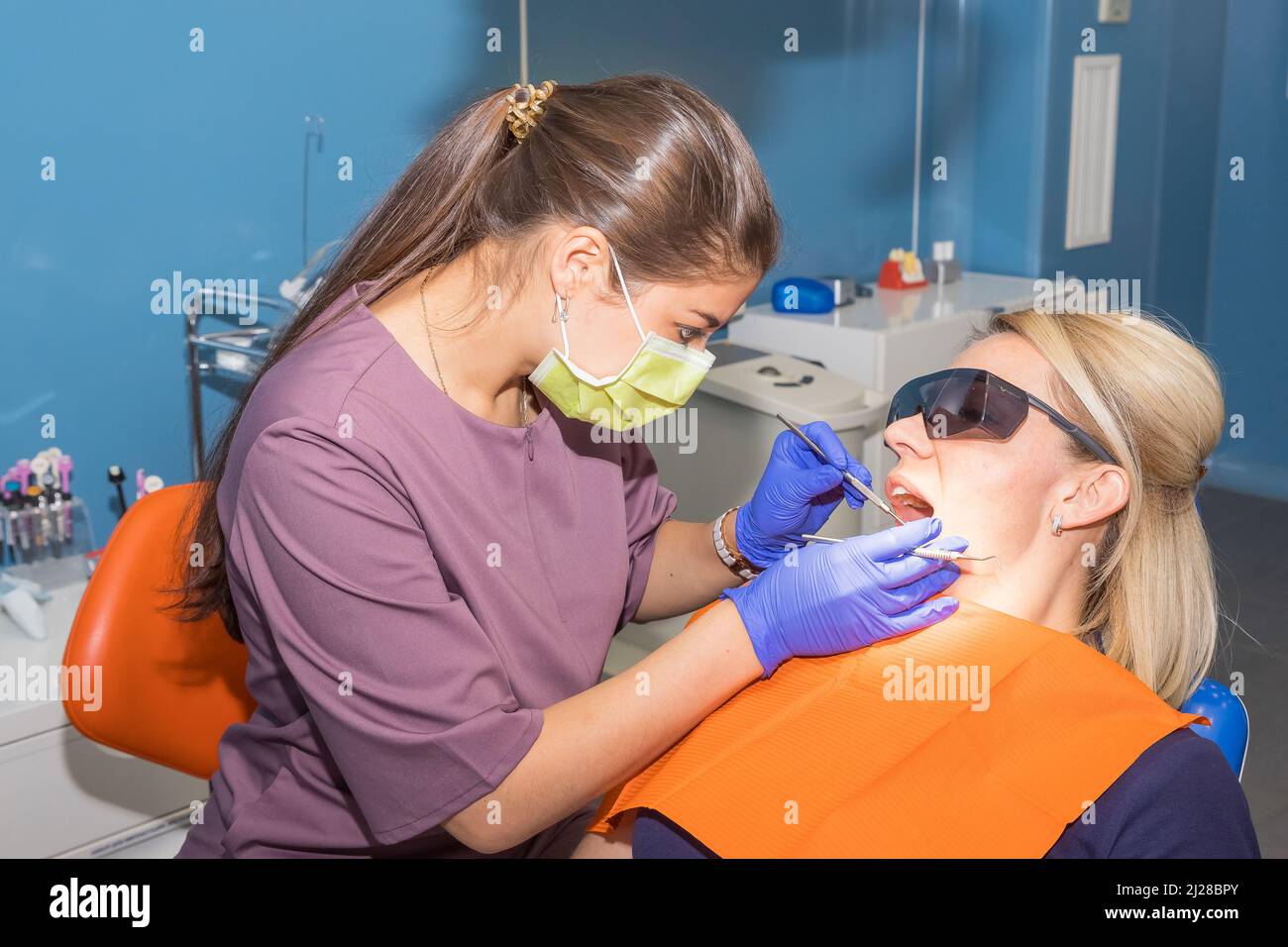 Russia, Moscow, 2 march 2022.Young smiling female dentist working with ...