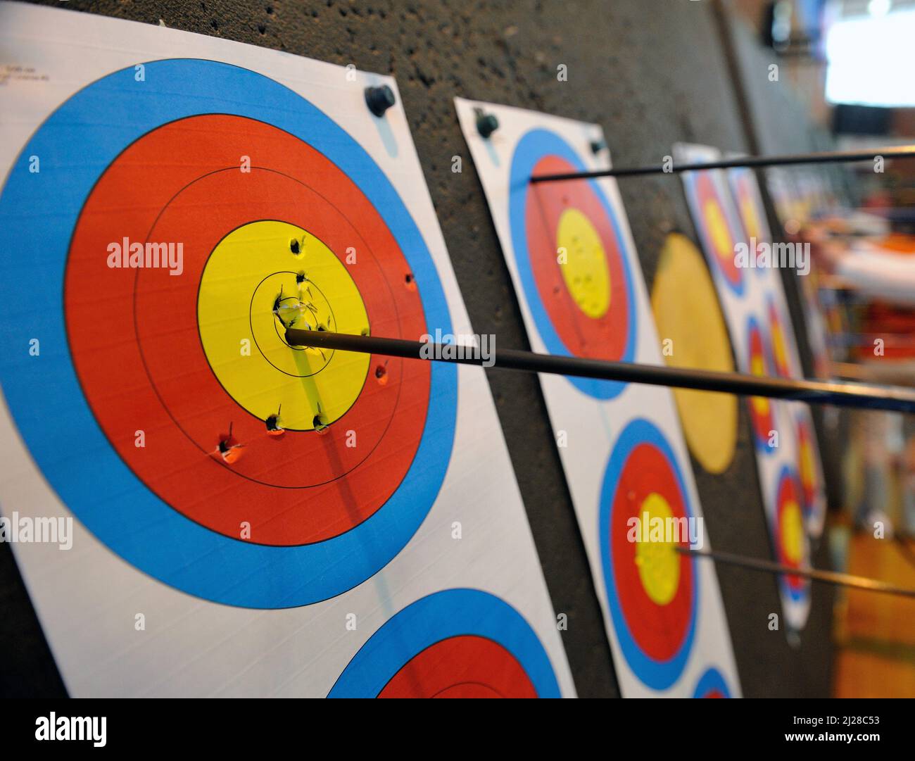 A photo of arrows embedded in targets in a competition Stock Photo - Alamy