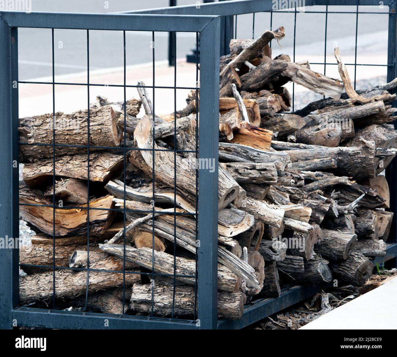 A wood bin loaded with firewood Stock Photo - Alamy