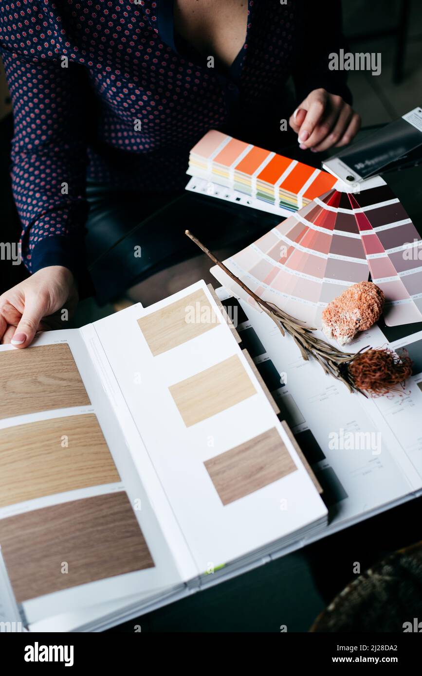Designer's Hand Choosing Color From Various Color Swatches In Office ...