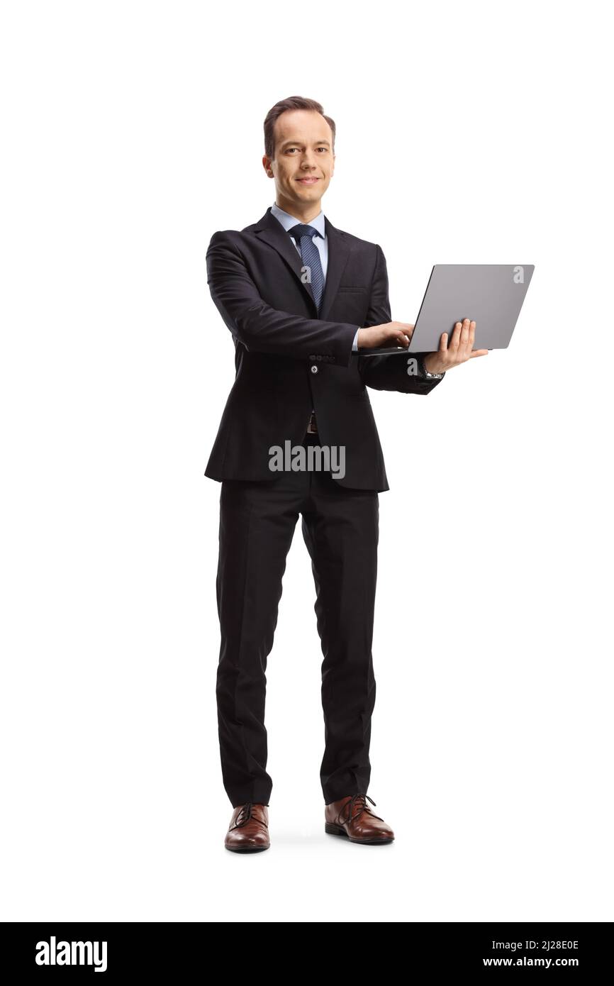 Full length portrait of a businessman holding a laptop computer and ...