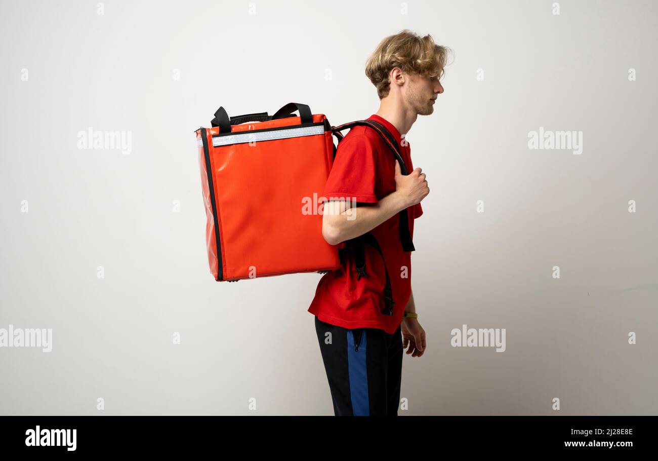 Delivery Service Cocnept. Portrait of male courier wearing red uniform ...