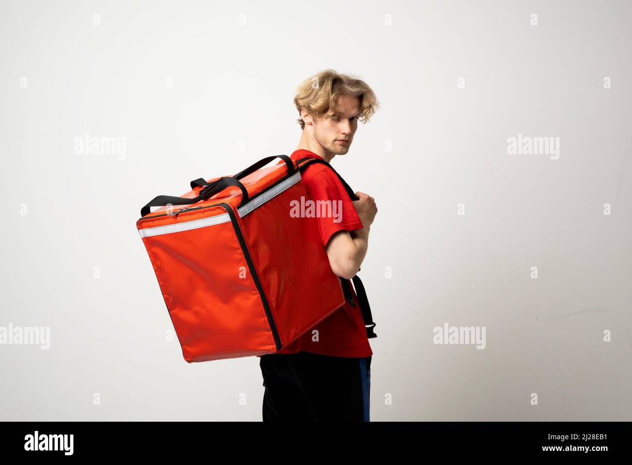 Delivery Service Cocnept. Courier wearing red uniform and thermo ...