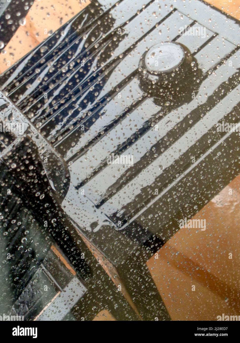 Semi-abstract still-life of rain on black plastic chair, Benidorm ...