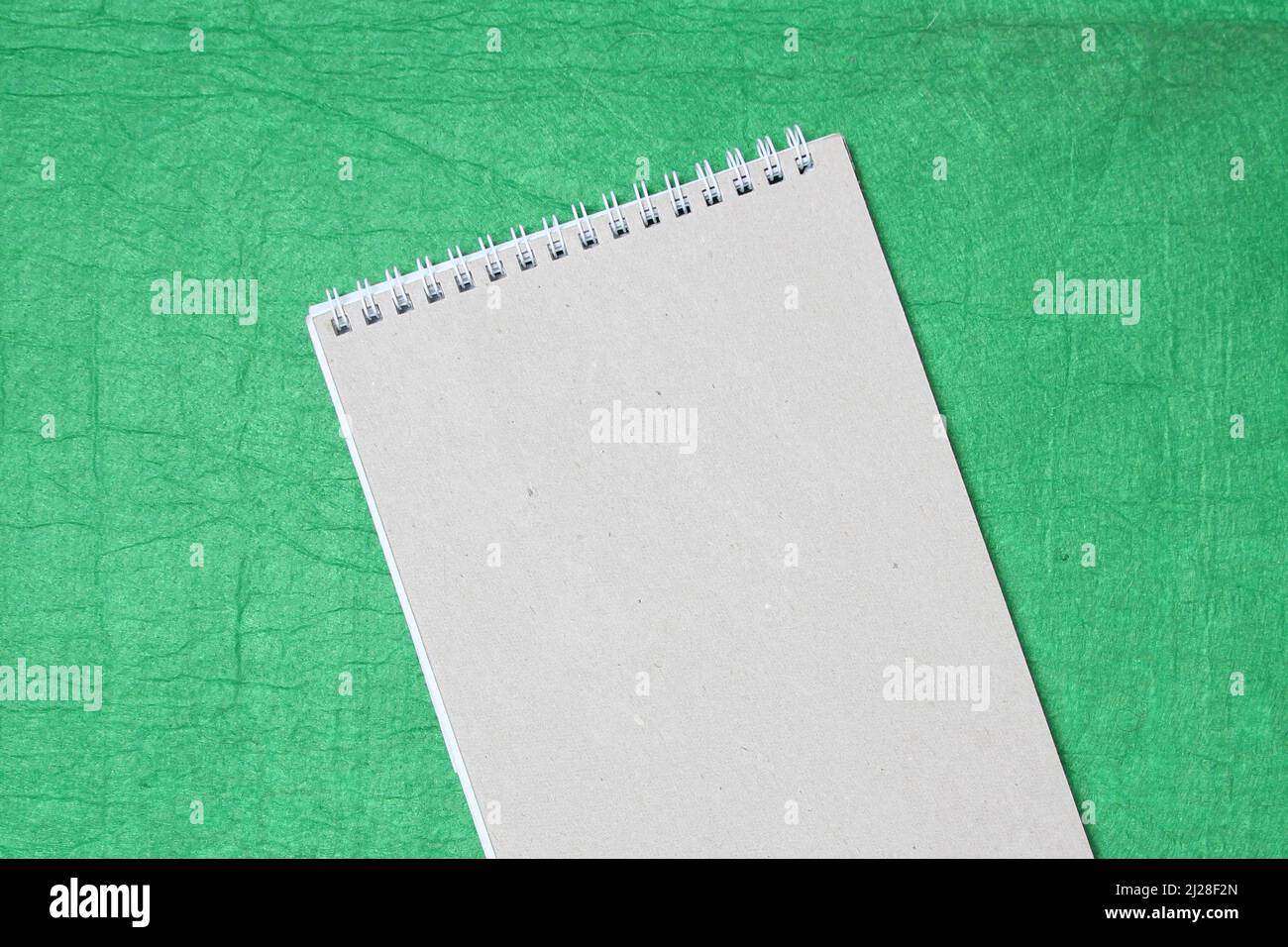 White and gray notepad sheet with spiral against the background of ...