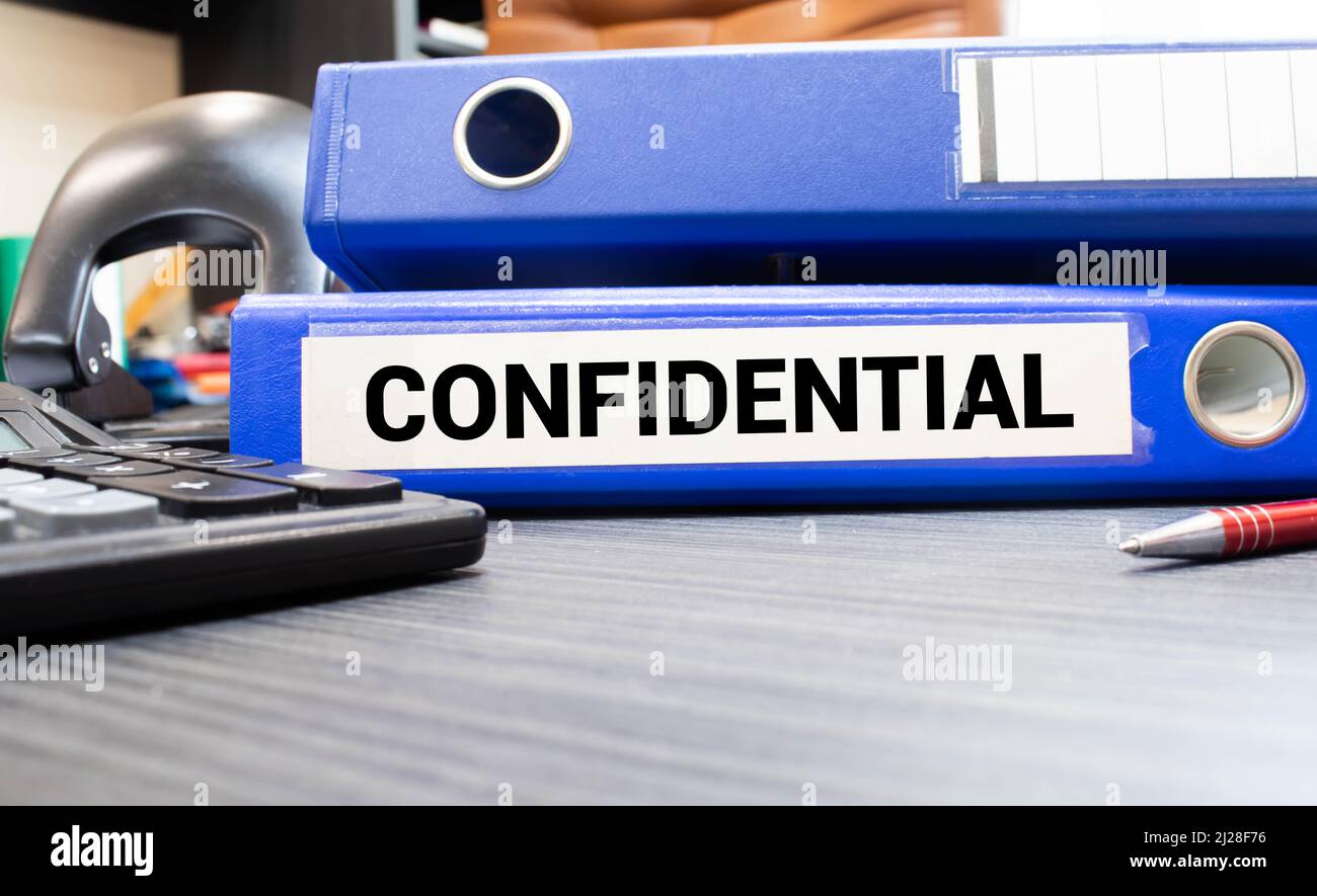 Inside of a filing cabinet with green folders and focus on confidential ...