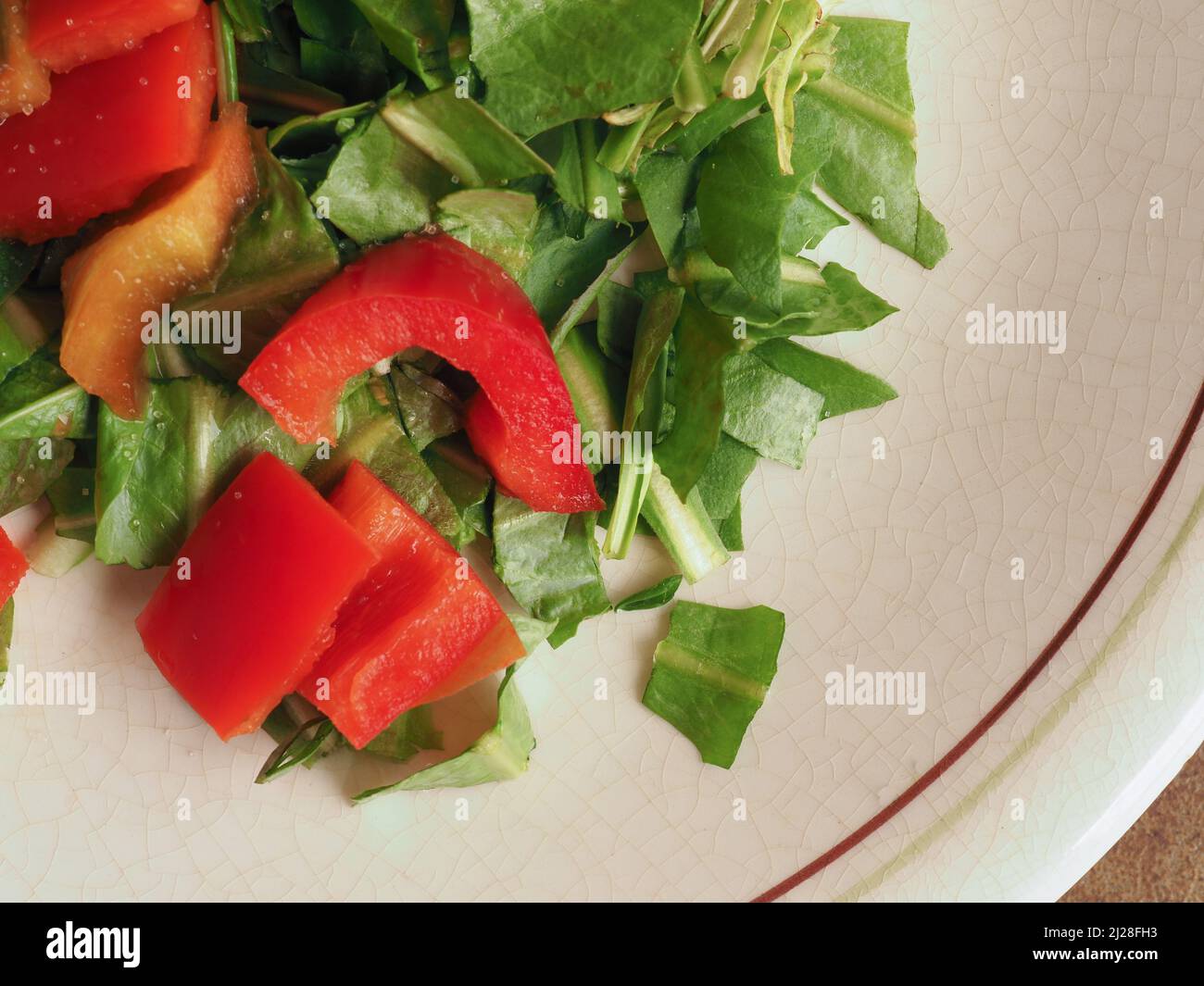 lettuce and red peppers salad dish background Stock Photo - Alamy