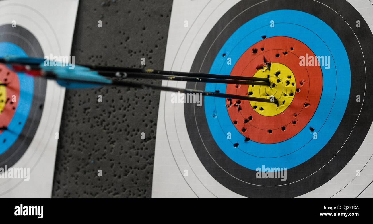 Some arrows on the target in the archery competition Stock Photo - Alamy