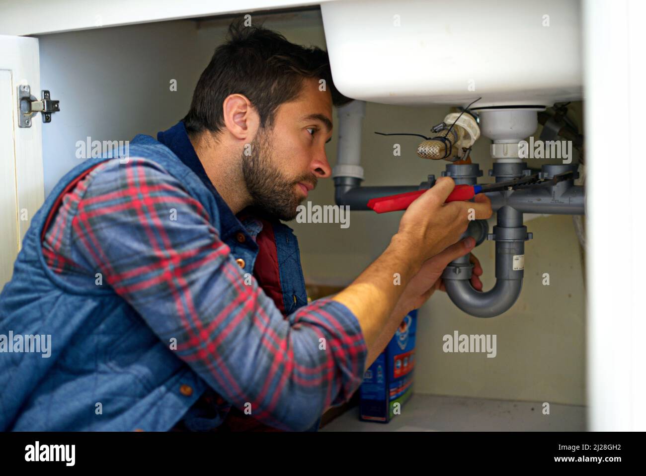 I think I see your problem. Shot of a plumber fixing a pipe Stock Photo ...
