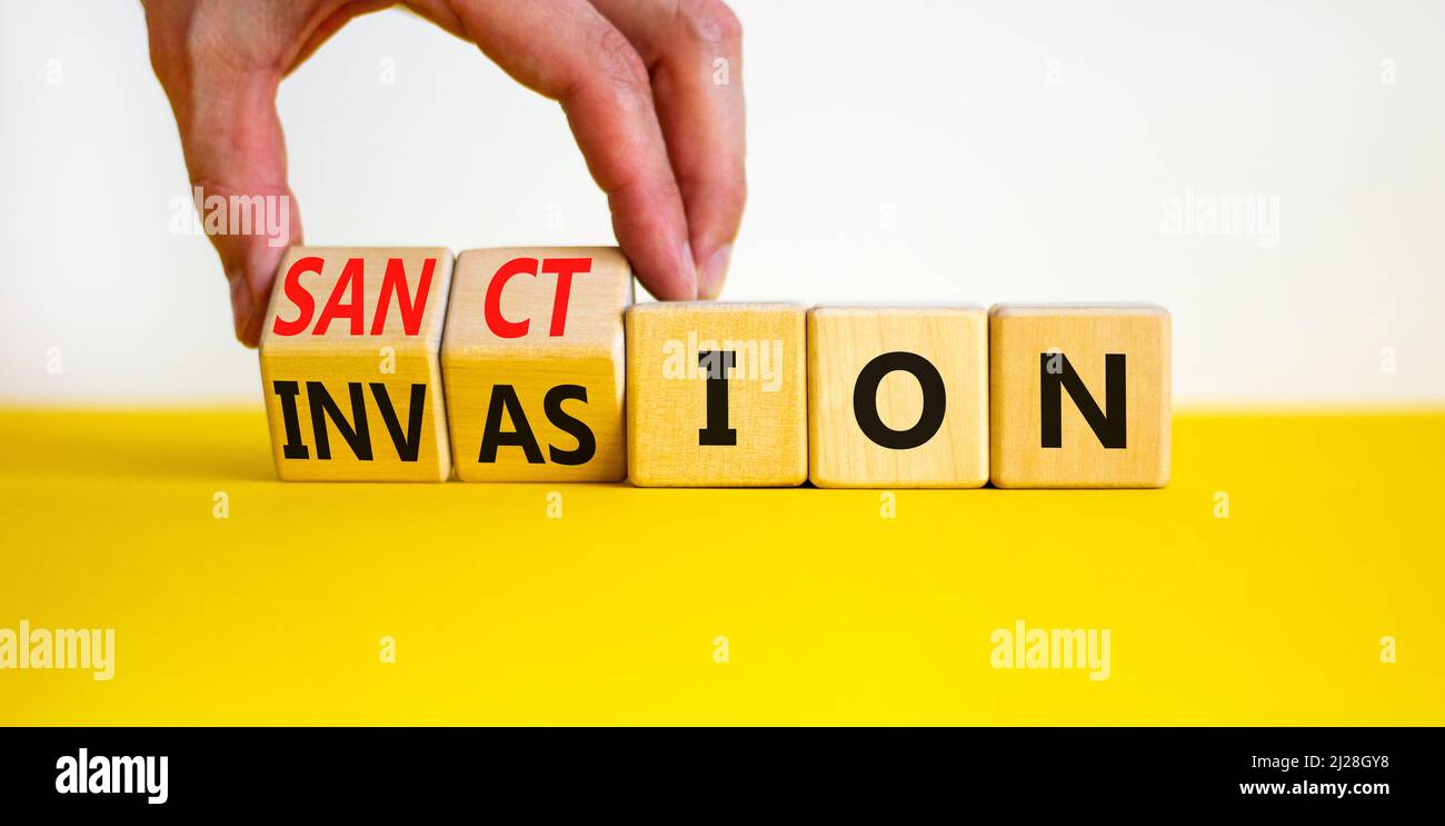 Sanction against invasion symbol. Businessman turns cubes and changes ... Sanction against invasion symbol. Businessman turns cubes and changes ...