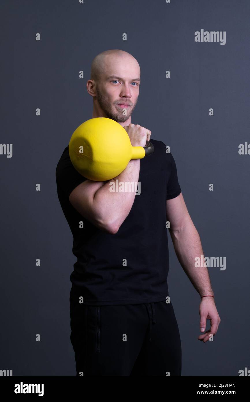 Guy with a yellow kettlebell gym anonymous yellow man, in the afternoon ...