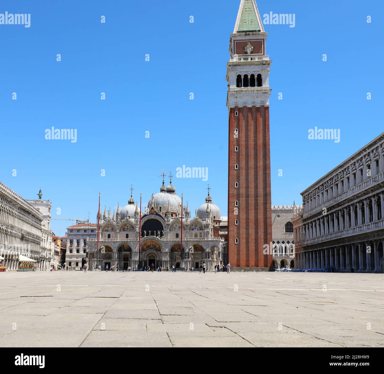 Nobody in Saint Mark Square in Venice in Italy during lockdown and the Basilica with bell tower ...