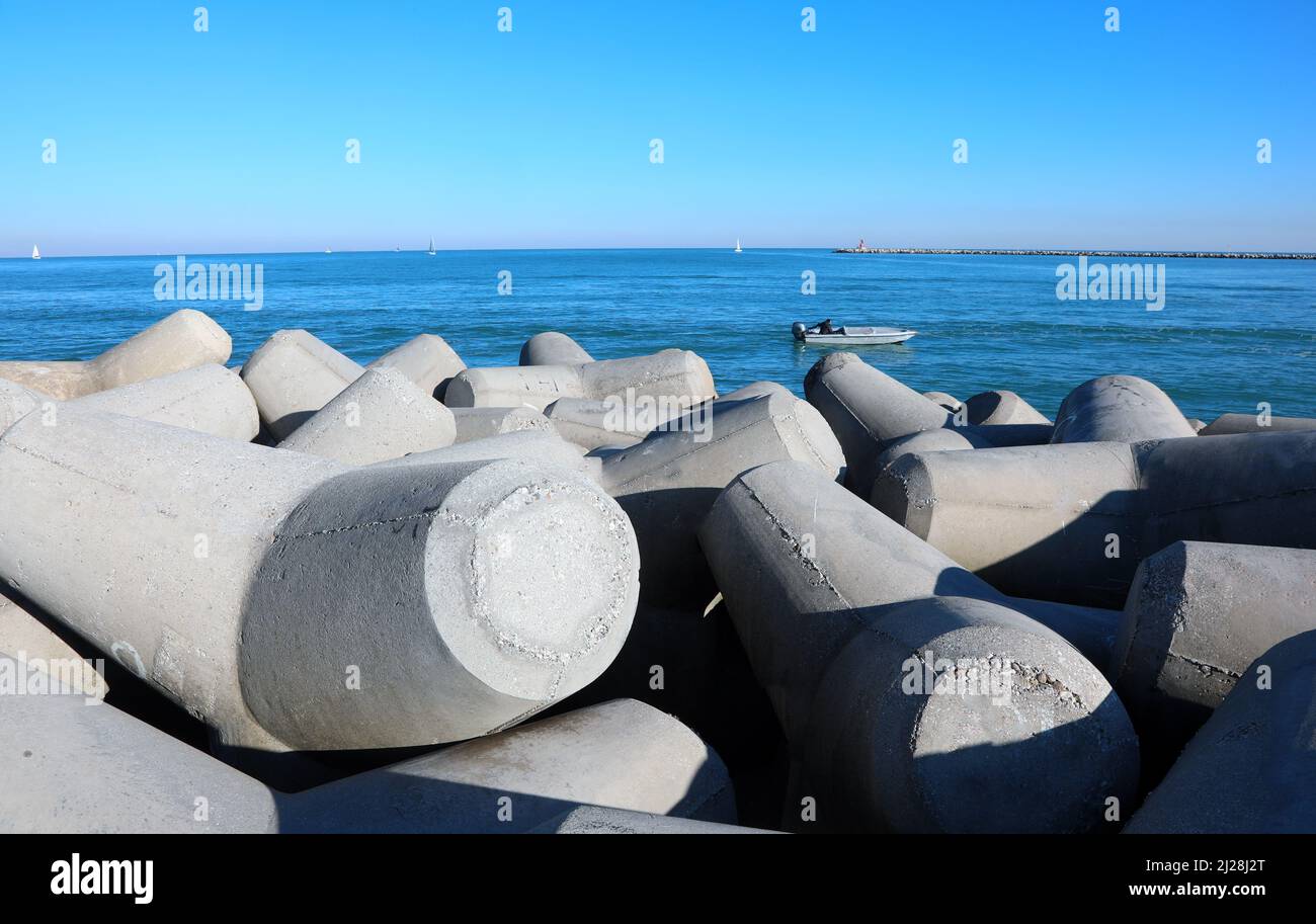 wide dam with many big breakwater also called groyne in concrete and ...