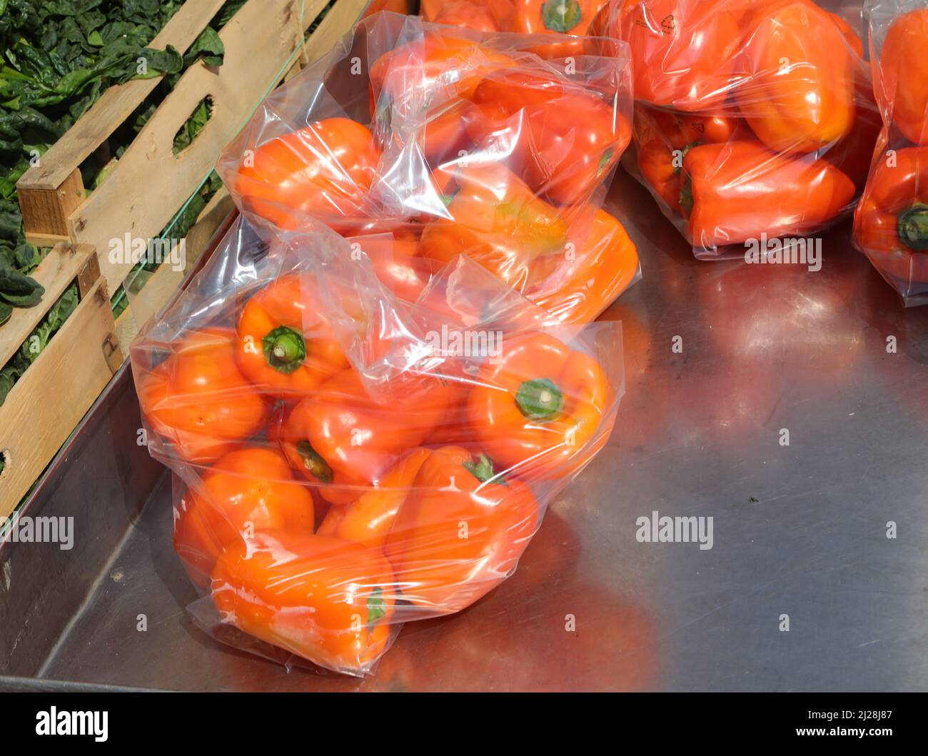 Bags of red peppers for sale in the greengrocers stall at the vegetable ...
