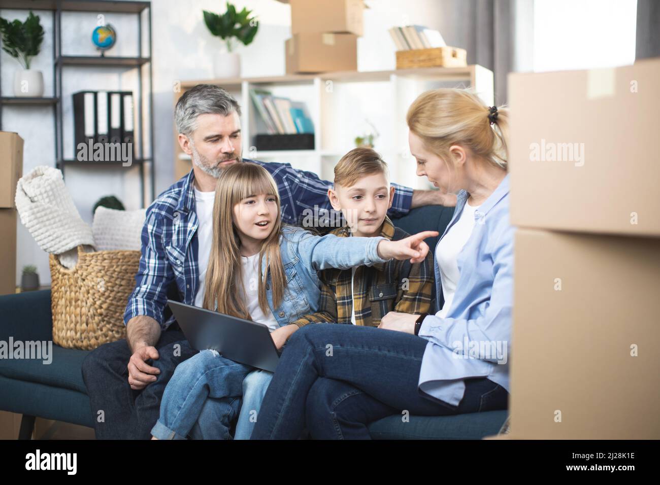 Happy big Caucasian family planning design on new apartment. Parents ...
