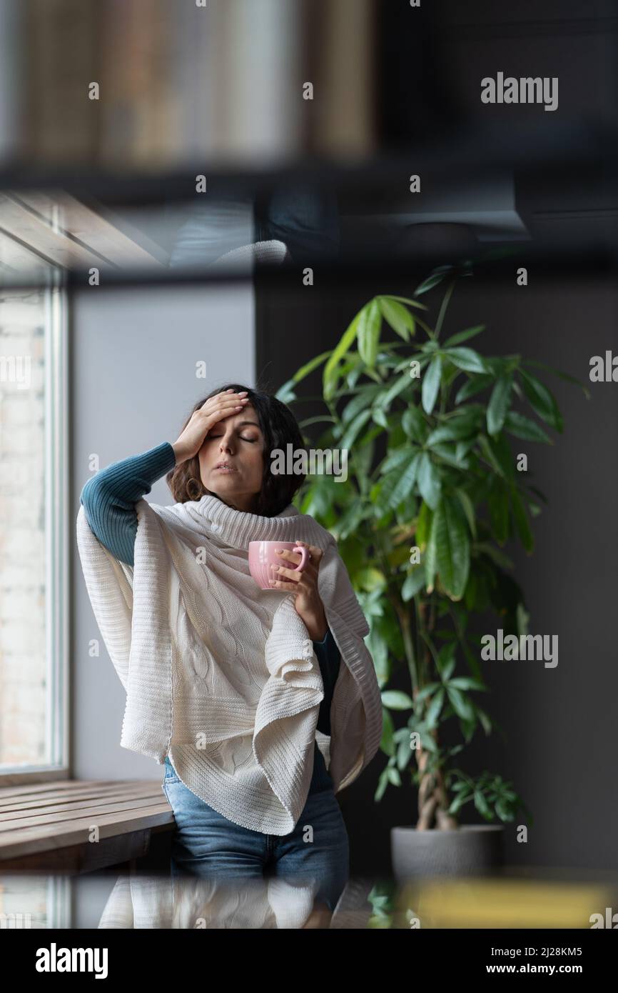 Unhealthy unwell businesswoman having fever touching forehead while ...