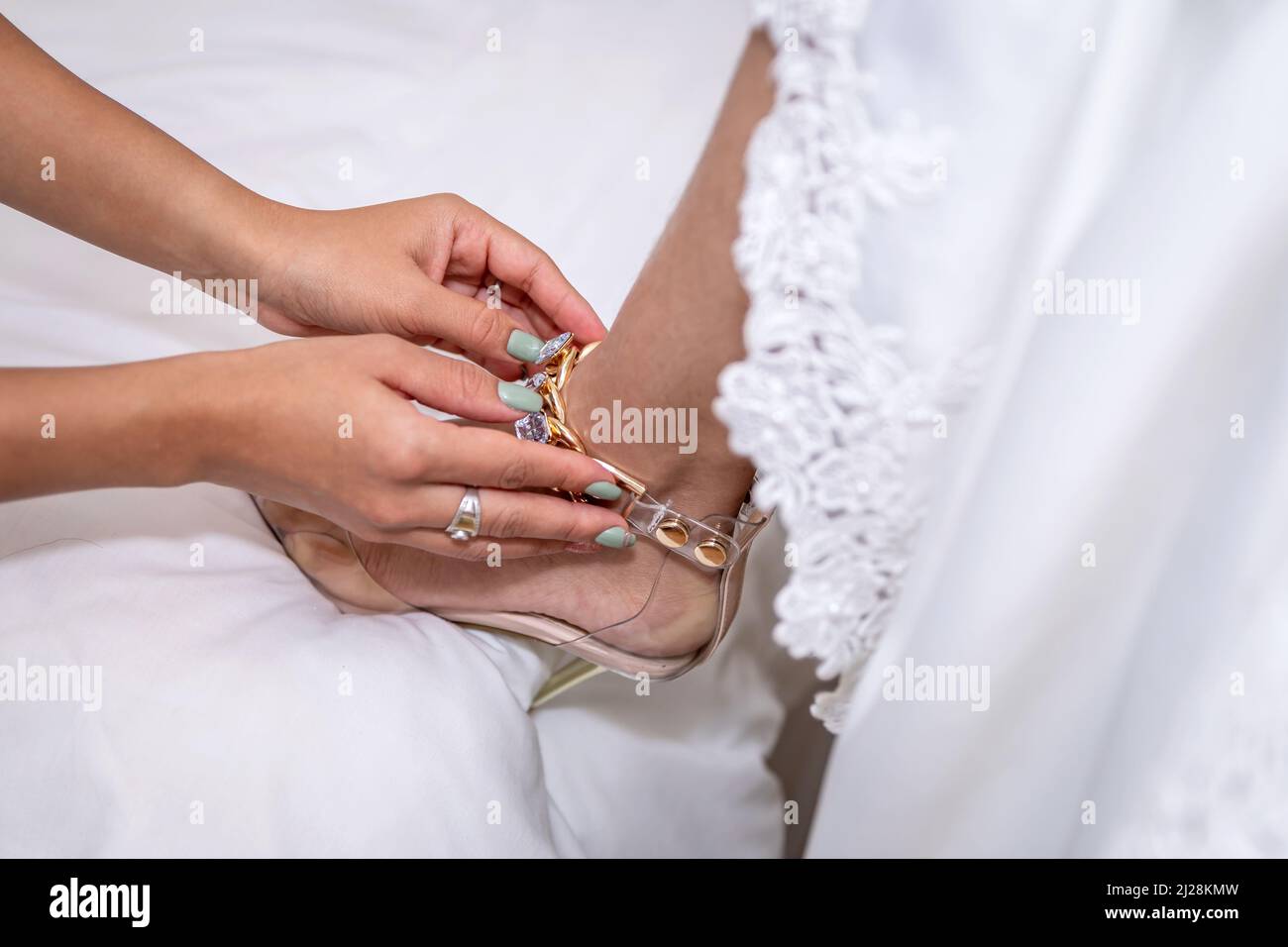 Bride getting ready, dressing, on her wedding day Stock Photo - Alamy