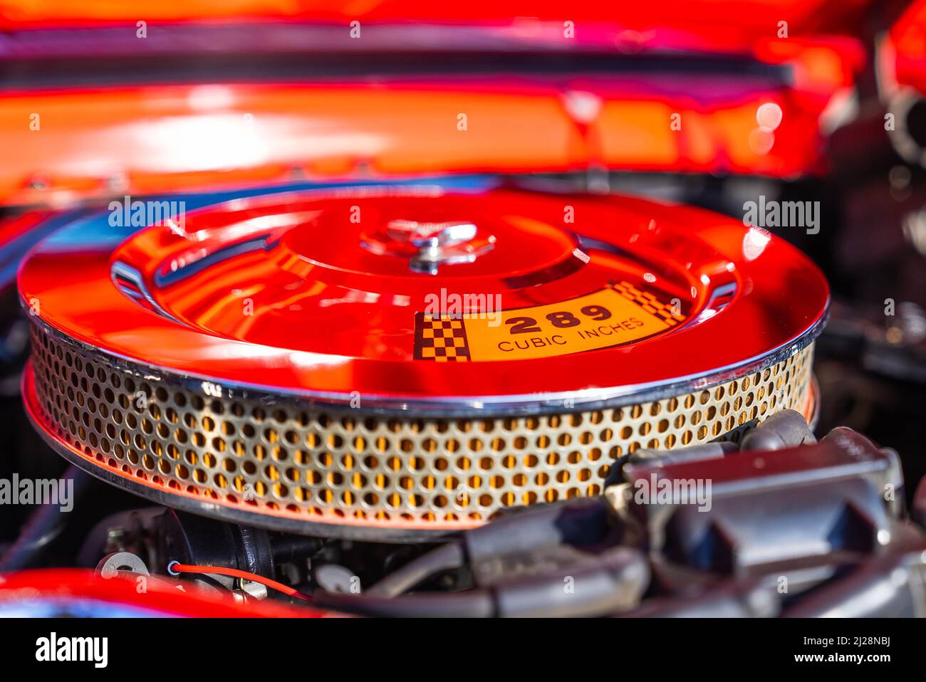 A closeup of the engine of a red 1966 Ford Mustang Stock Photo - Alamy